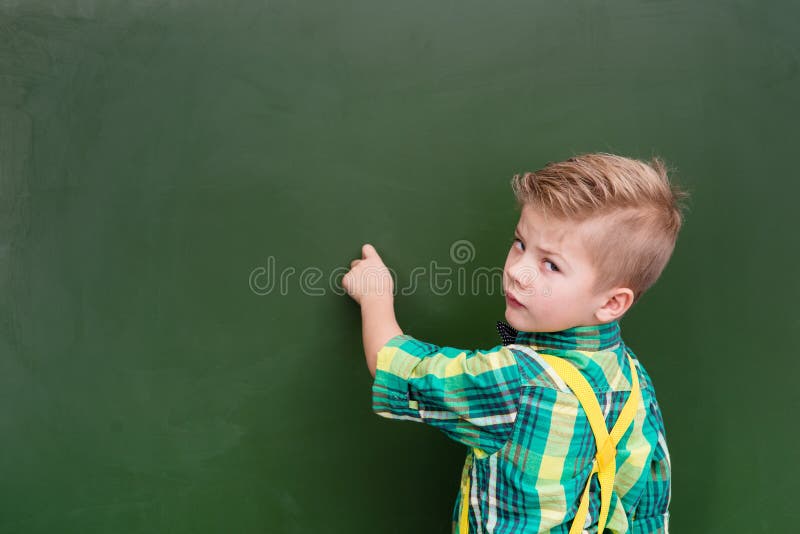 Young Boy Writing on a Green Chalkboard Stock Photo - Image of grade ...