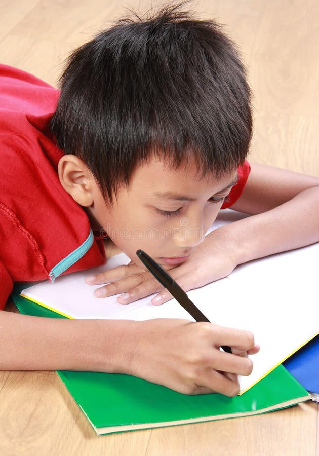 Young Boy Writing Something on the Book Stock Photo - Image of pressure ...