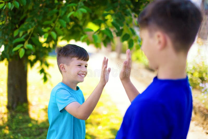Young Boys High Five at Park Stock Photo - Image of high, friendship ...