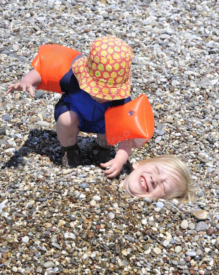 Young Boys Playing with Pebbles at Beach Stock Image - Image of play ...