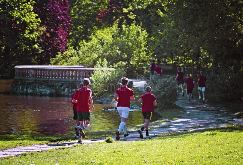 Young boys run in park editorial image. Image of friendship - 58761800