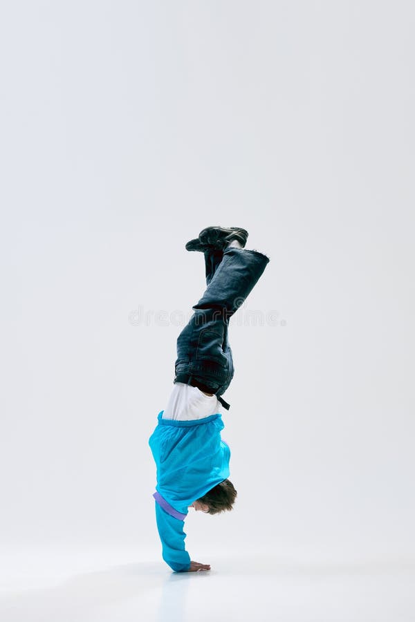 Young Breakdancer Balancing on One Hand Against White Background. Ffull ...