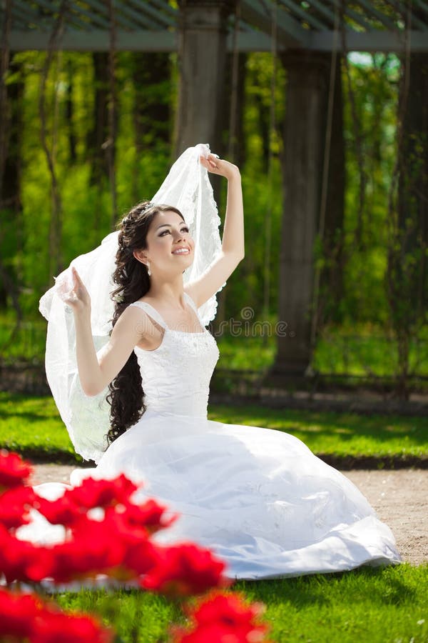 Beautiful Bride in a Blossoming Garden Stock Image - Image of bouquet ...