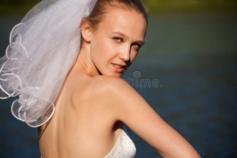 Bride Glances Over Her Shoulder Stock Photo - Image of pearl ...