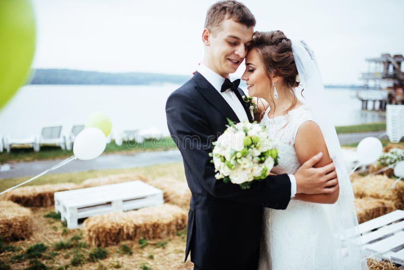Young Bride Hugging Her Groom in Beautiful Park Stock Photo - Image of ...