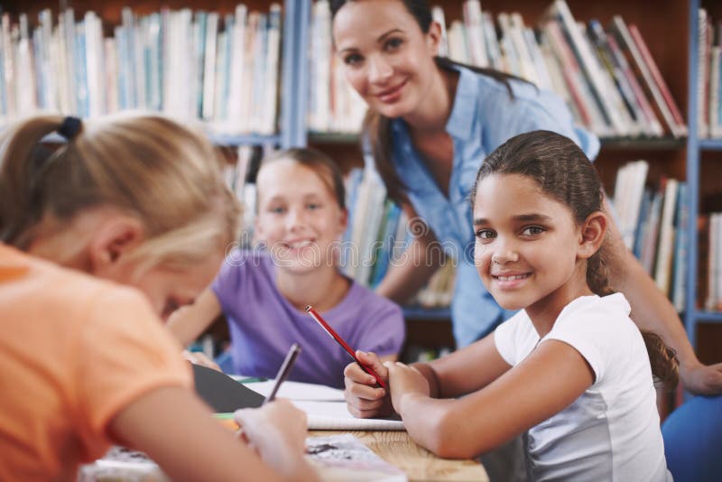 Young Bright Minds. a Young Girl Sitting in the Library Working with ...