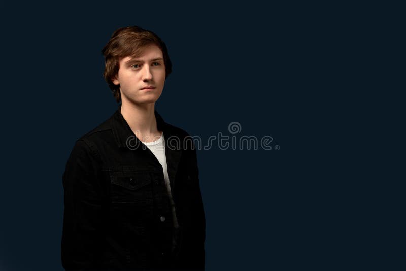 Young Brooding Guy Looks Down and Keeps the Finger Near the Cheeks ...