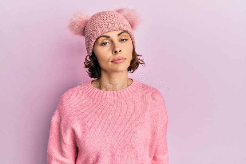 Young Brunette Woman Wearing Cute Wool Cap Relaxed With Serious