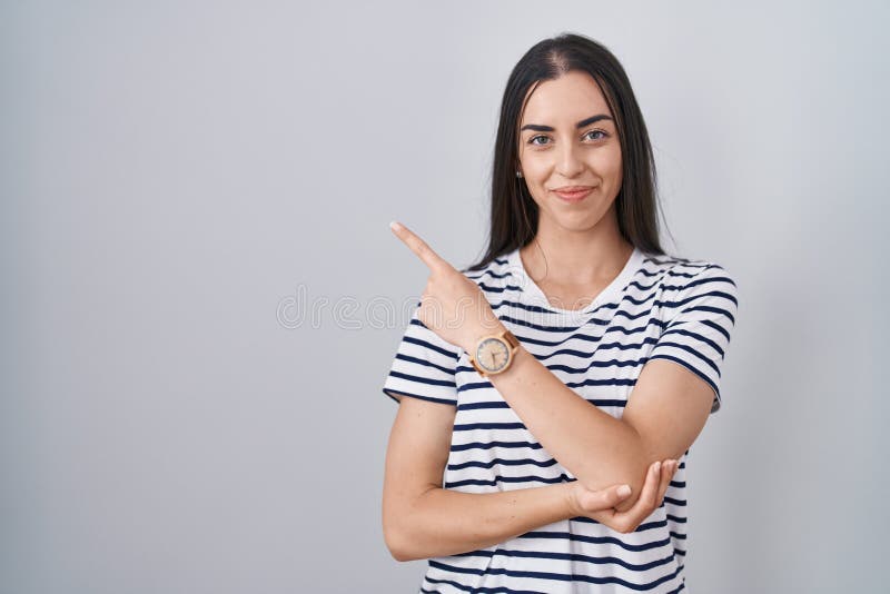 Young Brunette Woman Wearing Striped T Shirt Pointing With Hand Finger