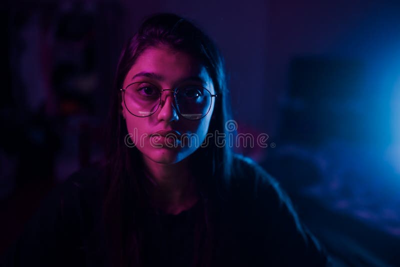 Young Woman Working at Night with Serious Expression on Face. Stock ...