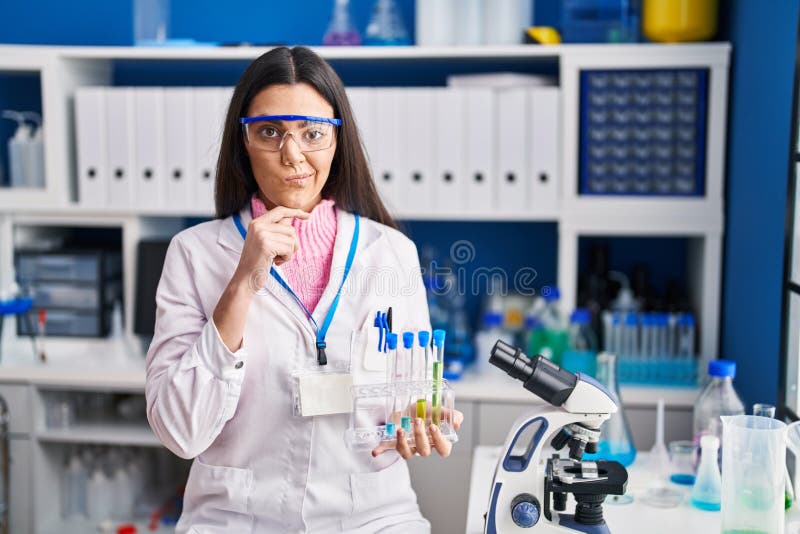 Young Brunette Woman Working at Scientist Laboratory Serious Face ...