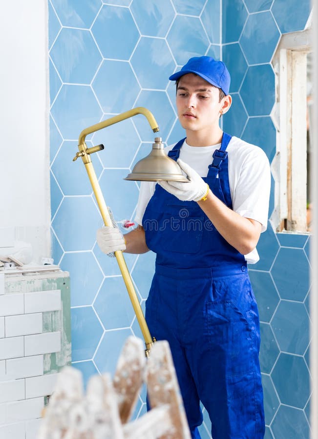 Young Builder Assembling Shower Set before Fixing To Wall Stock Photo ...