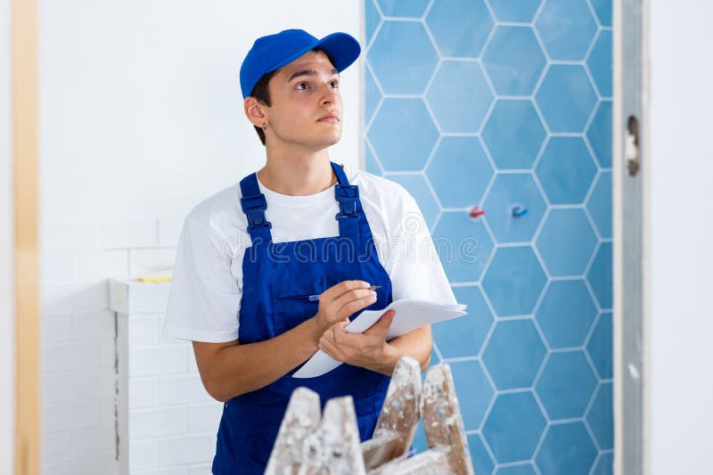 Young Builder Making Checklist while Planning Indoor Building Overhaul ...