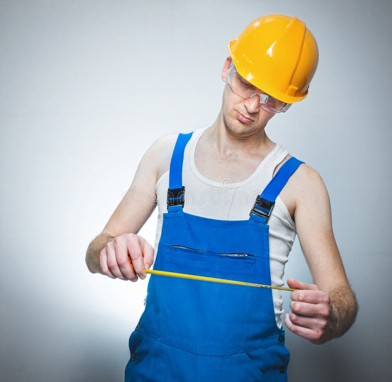 Young builder with meter stock photo. Image of working - 63985312