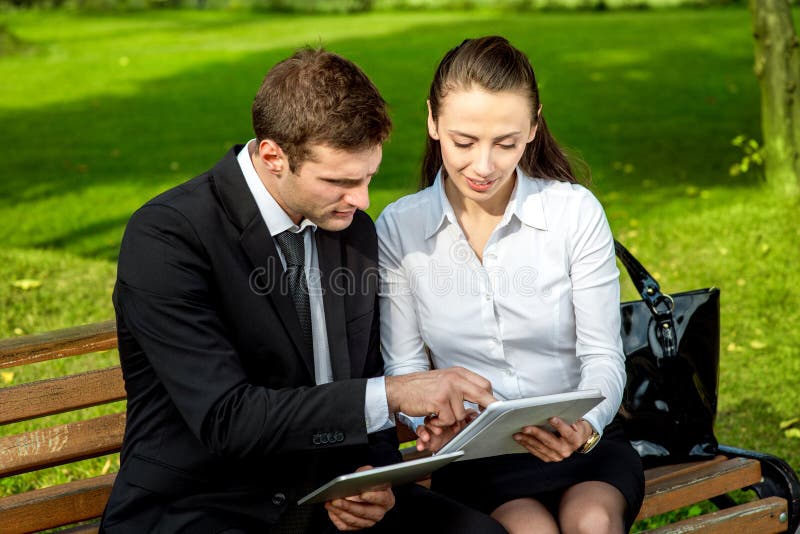 Young Business Couple Outdoors. Stock Photo - Image of read, gadget ...