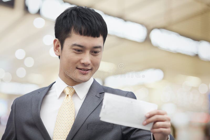 Young Business Man Looking at Flight Ticket Stock Photo - Image of ...