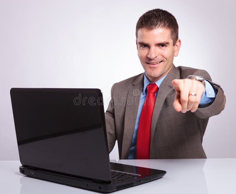 Young Business Man Points Camera Smiling Behind Laptop Stock Photos ...