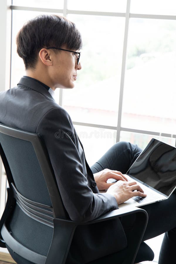 Young Business Men Sit and Work in the Office he Put the Laptop ...