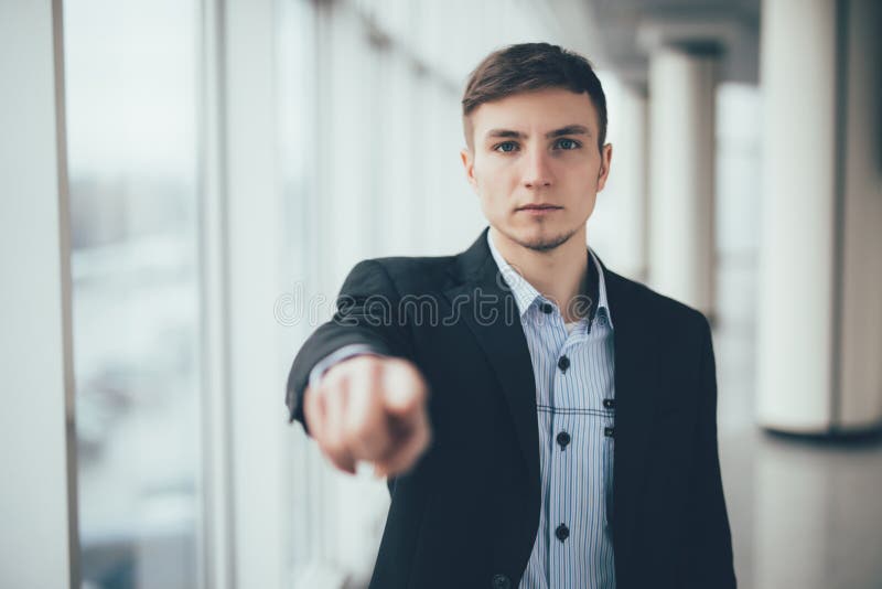 Young Business Man in a Suit Pointing with His Finger Office Stock ...