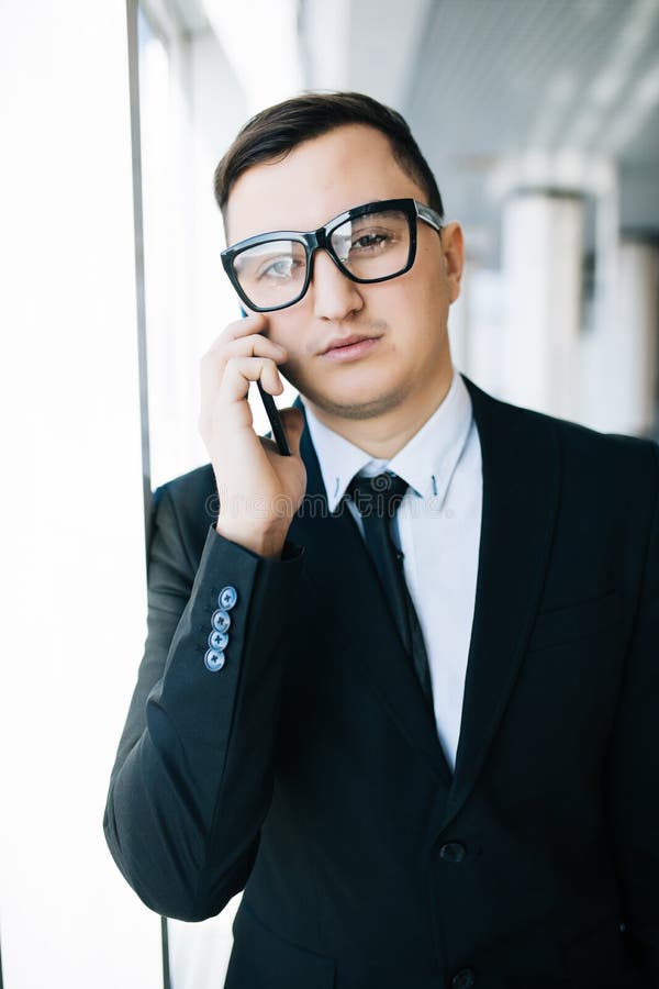 Young Business Man Talk on Phone Against Windows Stock Image - Image of ...