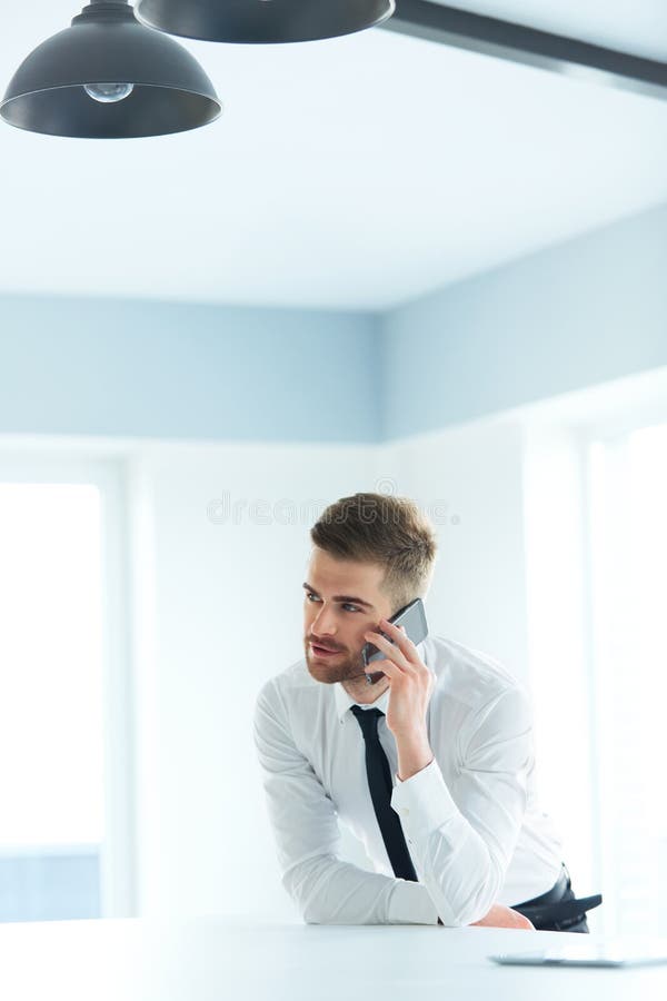 Young Business Man Talking on Cell Phone at Modern Office Stock Photo ...