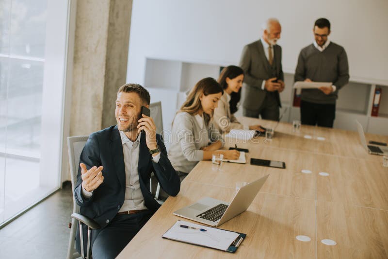 Young Business Man Using Mobile Phone in the Office Stock Image - Image ...
