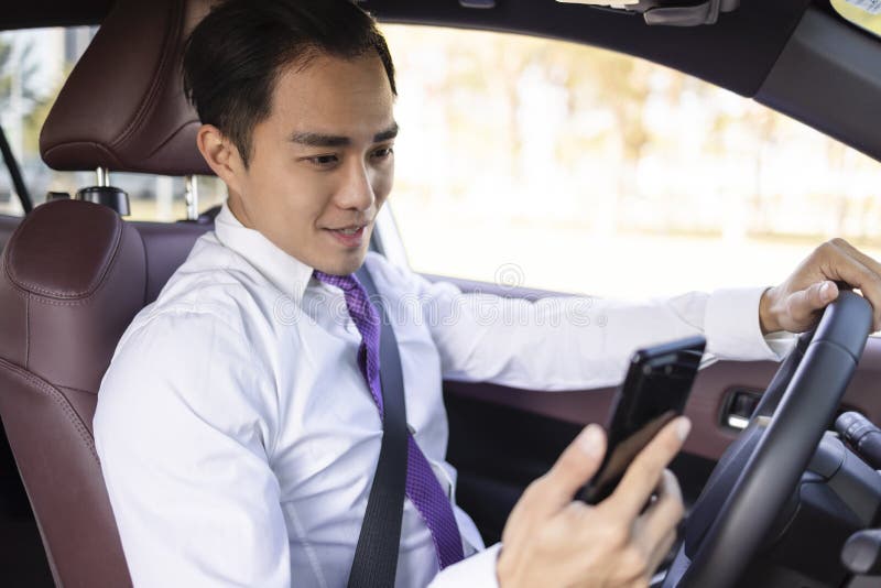 Young Business Man Watching Mobile Phone in the Car Stock Photo - Image ...