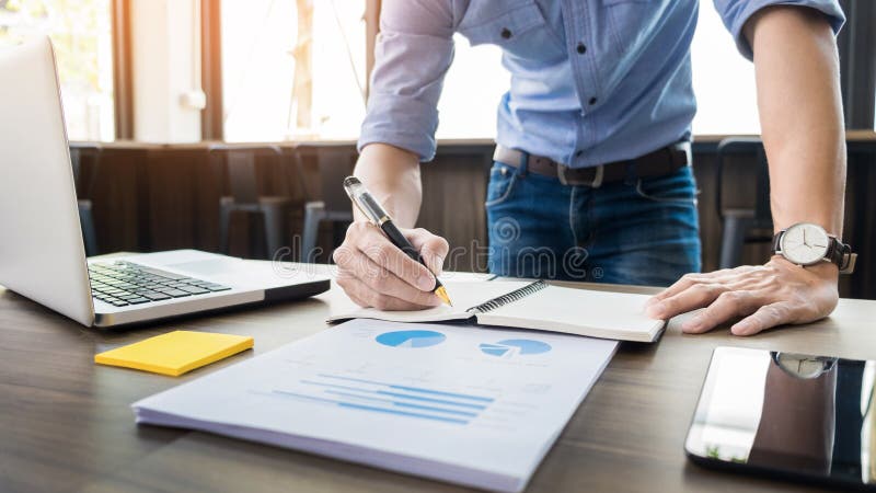 Young Business Man Working in Bright Office, Using Laptop, Writing ...