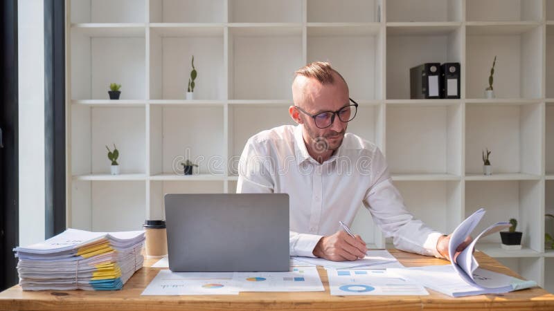 Young Business Man Working at Office with Laptop and Papers on Desk ...