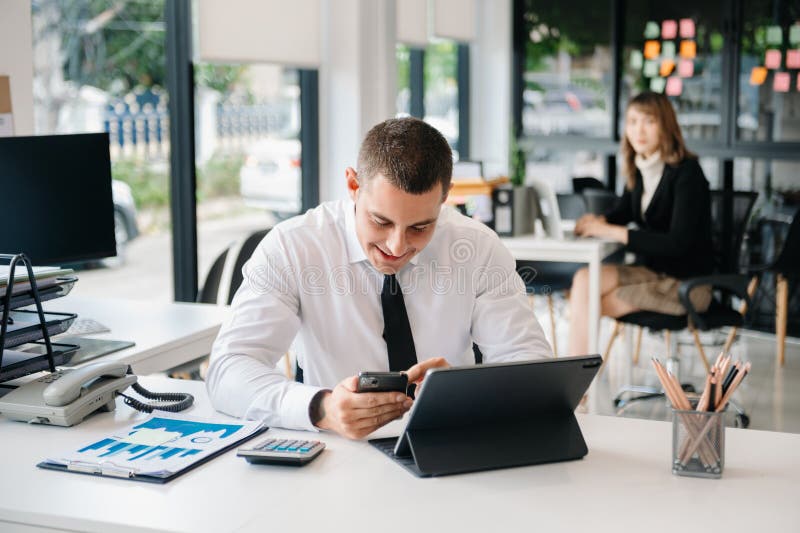 Young Business Man Working at Office with Smartphone, Tablet and Taking ...