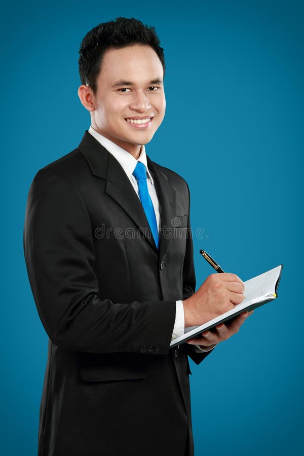 Young business man writing stock photo. Image of signing - 23968216