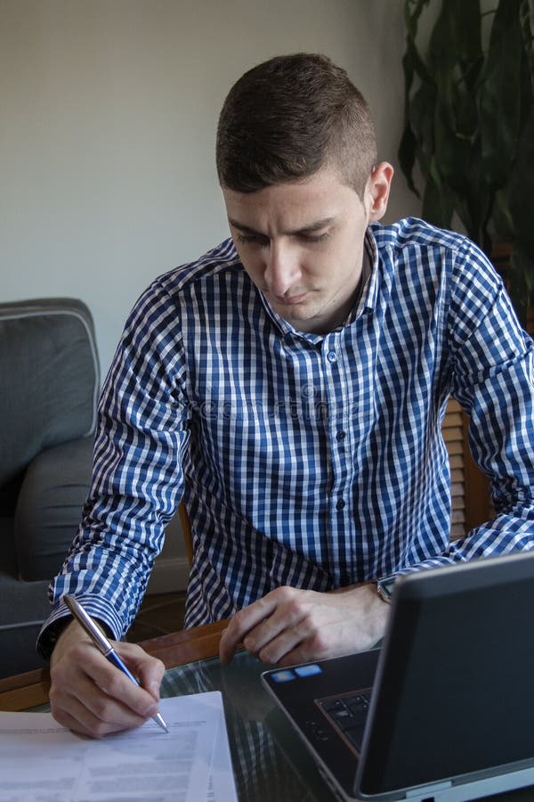 Young Business Man Writing on Paper at Home Office Stock Image - Image ...