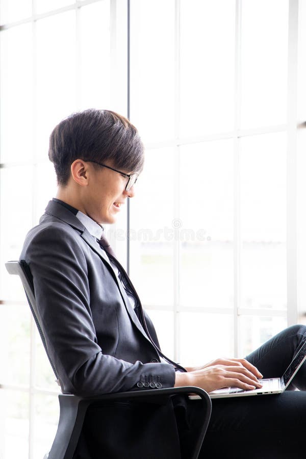 Smiling Young Businessman Talking on His Smartphone while he Working ...