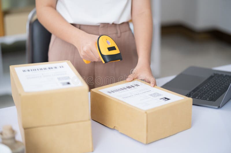 Young Business Online Woman Scanning Package Label with Barcode Reader ...