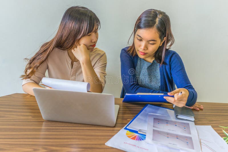 Young Business People Discussing and Analyzing Financial Statistics ...