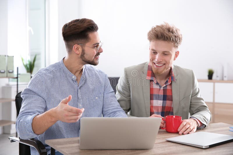 Young Business People Discussing Work Matters in Office. Stock Image ...
