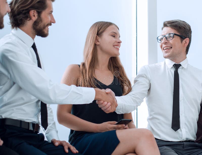 Young Business People Greeting Each Other with a Handshake Stock Photo ...