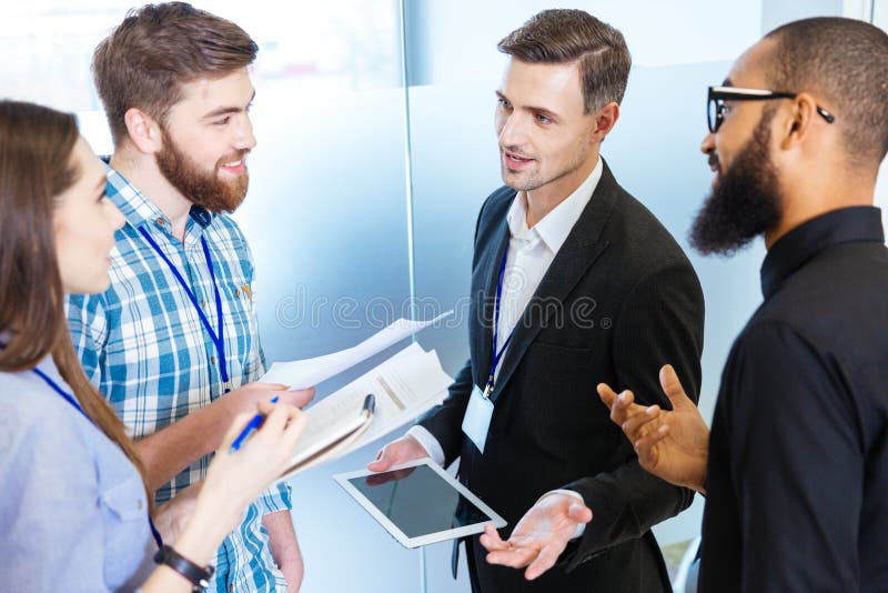 Young Business People Standing and Talking with Chief Executive Stock ...