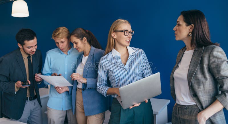 Young Business People or Students Standing in an Office and Interacting ...