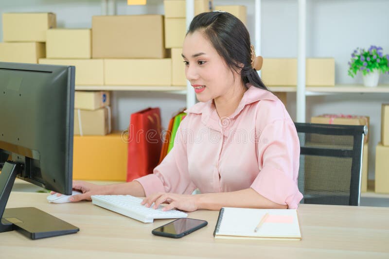 Small Business Owner, Woman Checking Purchase Order in Laptop and Write ...