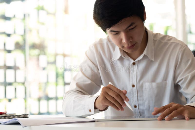 Young Business Using Smart Tablet for Analysis Financial Report Stock ...