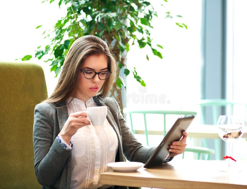 Young Business Woman with a Cup of Coffee Working in Office Stock Photo ...