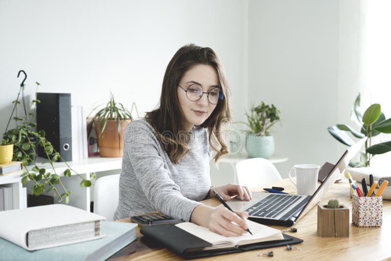 Young Business Woman Taking Notes in Notebook at Office. Stock Image ...