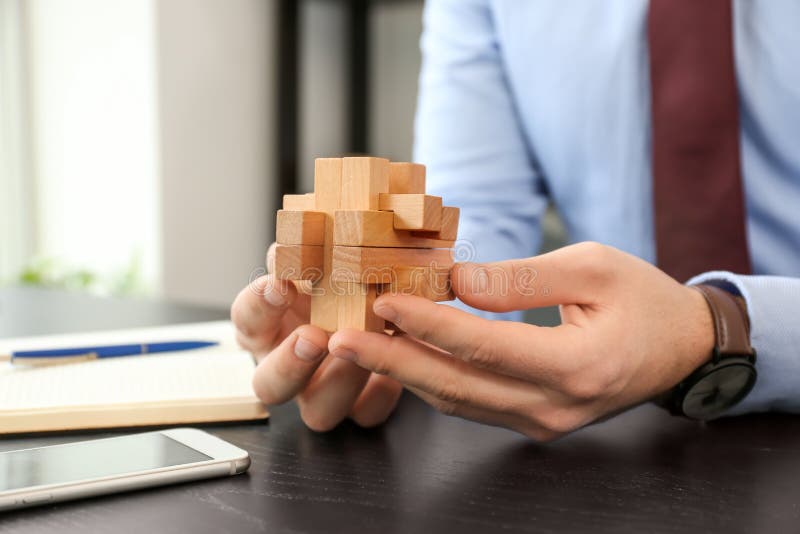 Young Businessman with Brain Teaser at Table in Office Stock Image ...