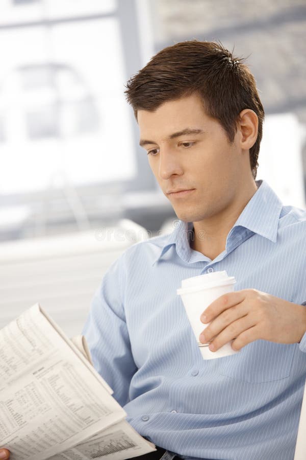 Young Businessman on Break Reading Papers Stock Photo - Image of ...
