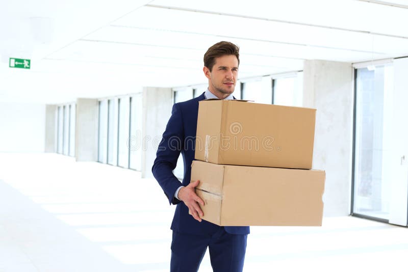 Young Businessman Carrying Cardboard Boxes in New Office Stock Photo ...