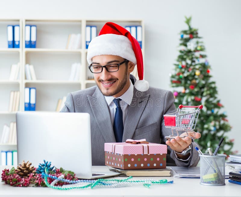 Young Businessman Celebrating Christmas in the Office Stock Photo ...