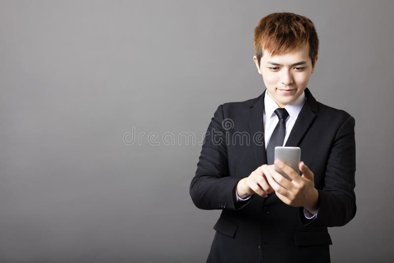 Young Businessman Checking Message on the Phone Stock Image - Image of ...