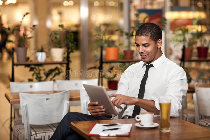 Young Businessman in the Coffee Break Working on His Ipad Stock Photo ...