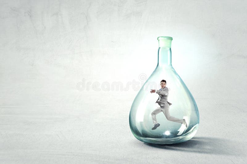 Young Businessman Dancing Inside Glass Bottle . Mixed Media Stock Photo ...